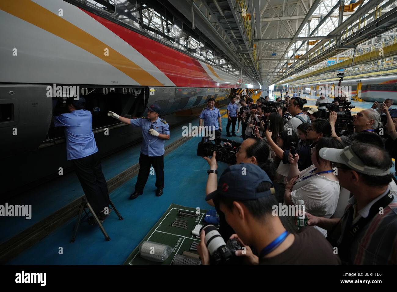 Journalists film railway workers demonstrating a service to a high ...