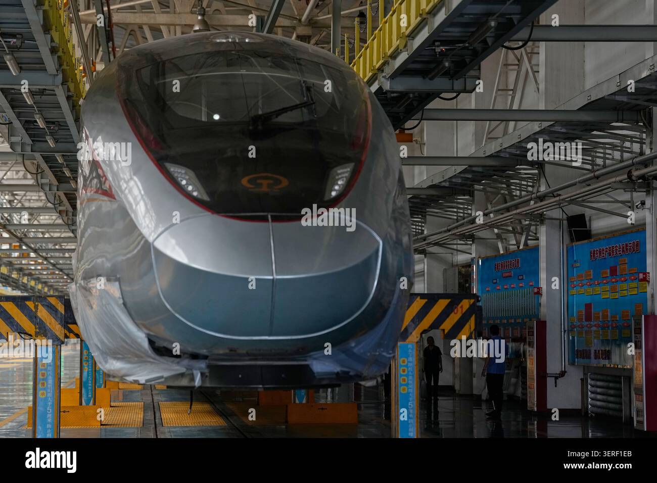 Railway worker chat near a high-speed electric multiple unit (EMU ...