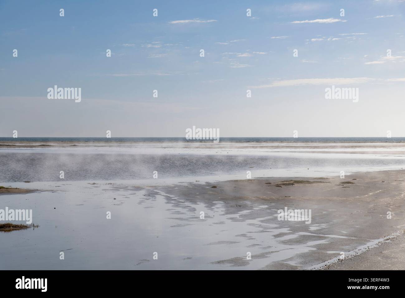 Tidal flat and sandbanks during low tide along the dunes of the island ...