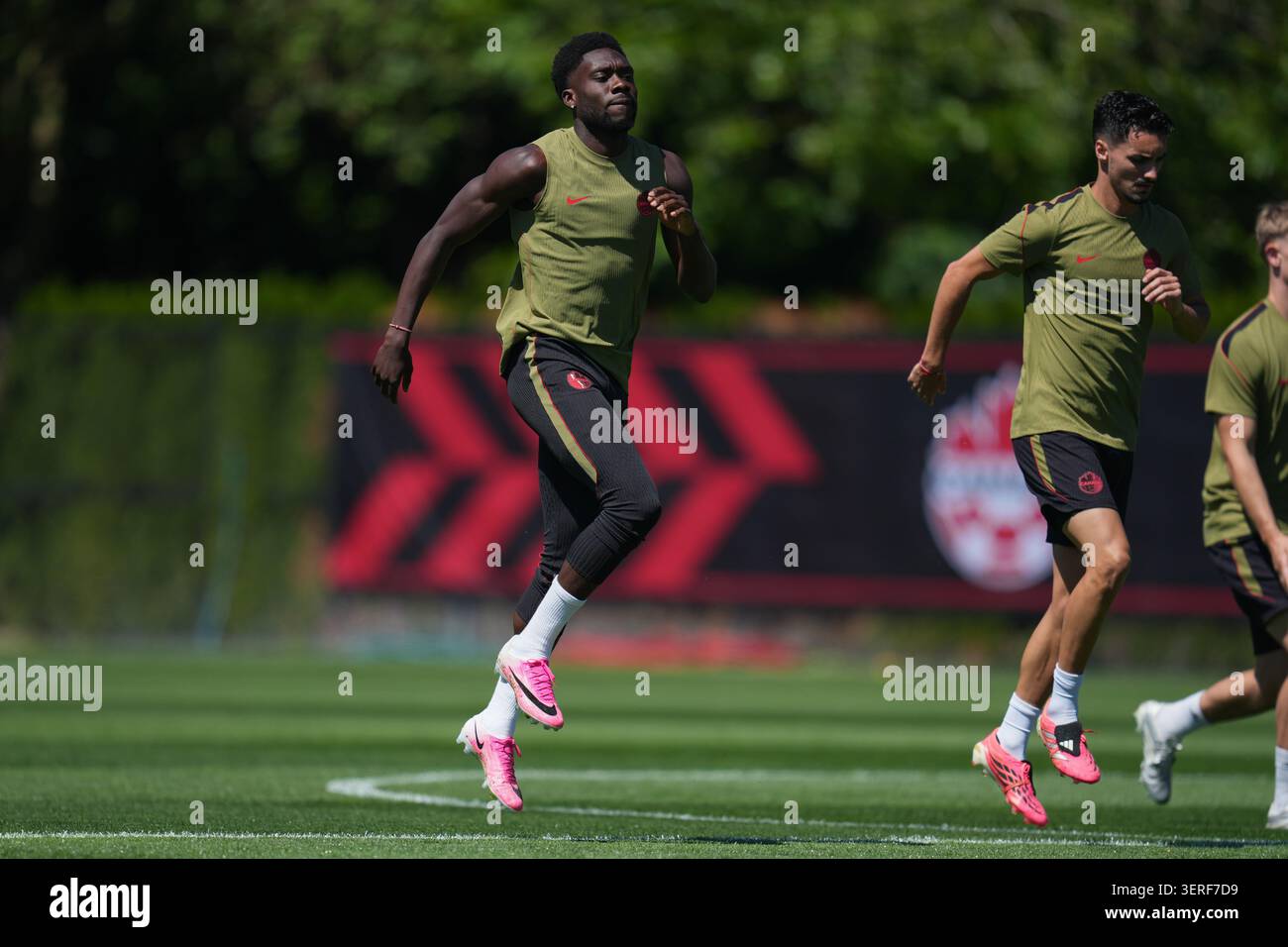 Canada's Alphonso Davies, left, works out during a training session on ...