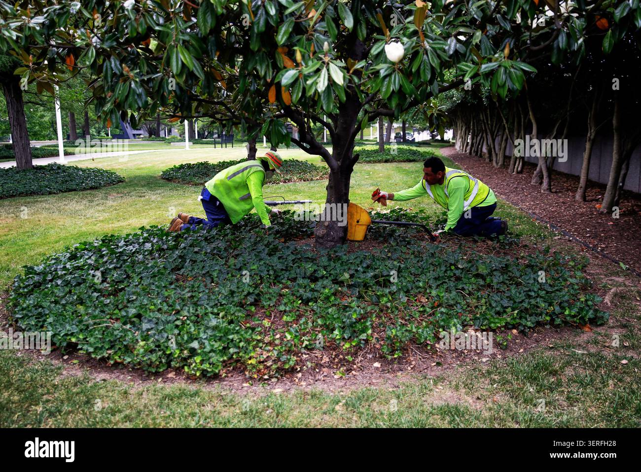 Workers tend a garden in front of the John F. Kennedy Center for the ...