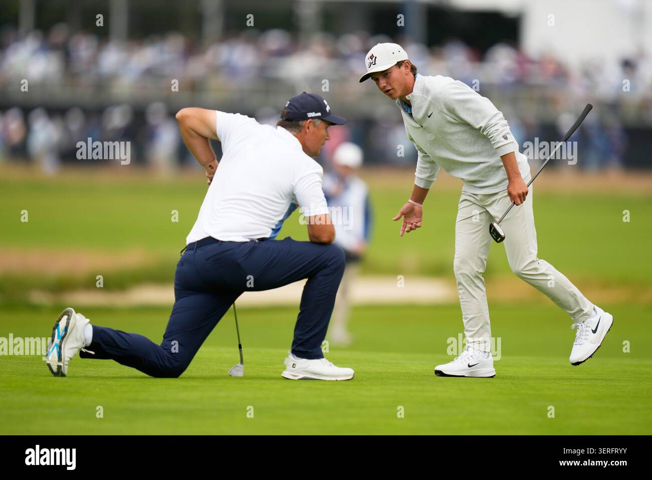 Miles Russell and Padraig Harrington, of Ireland, talk on the fourth ...