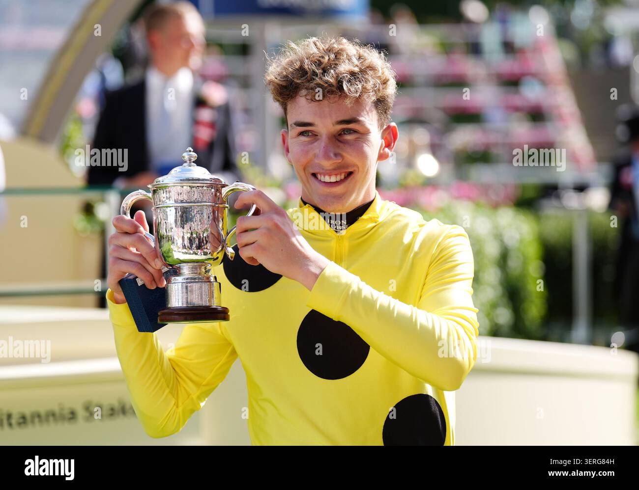 Jockey Zac Lloyd celebrates with the trophy after winning the Britannia ...