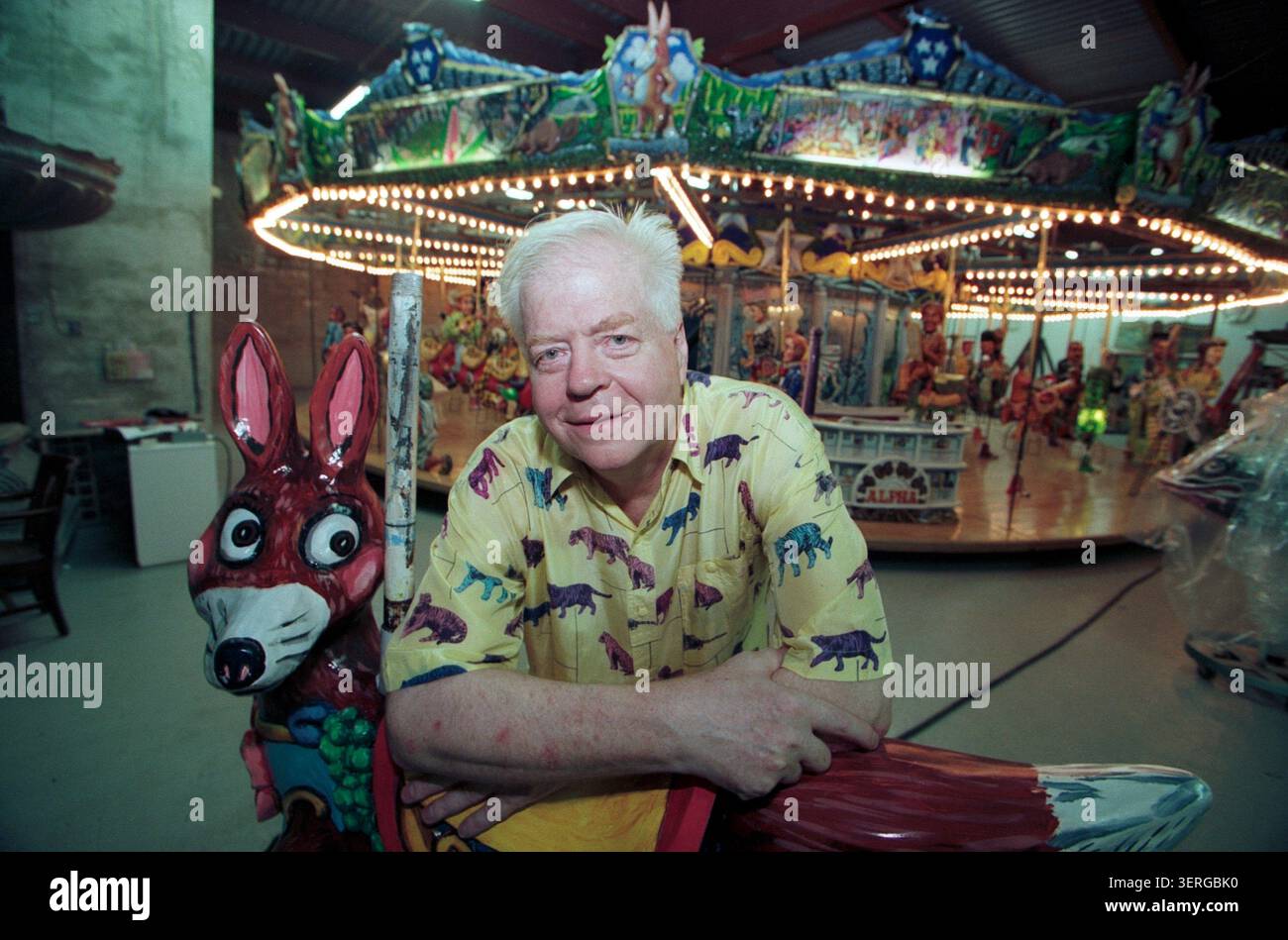 Artist Red Grooms poses in New York, July 16, 1998, with a fox, one of ...