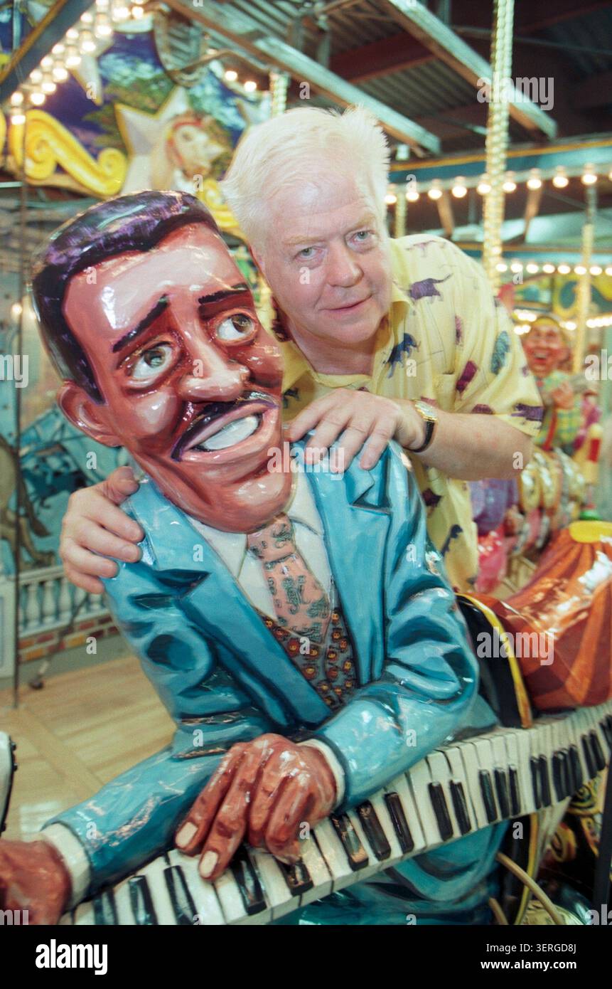 Artist Red Grooms poses in New York, July 16, 1998, with one of the ...