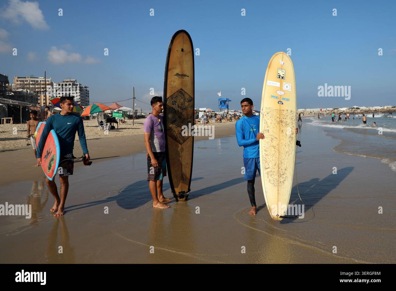 Palestinians practice surfing in the sea off Gaza City on June 16, 2026 ...