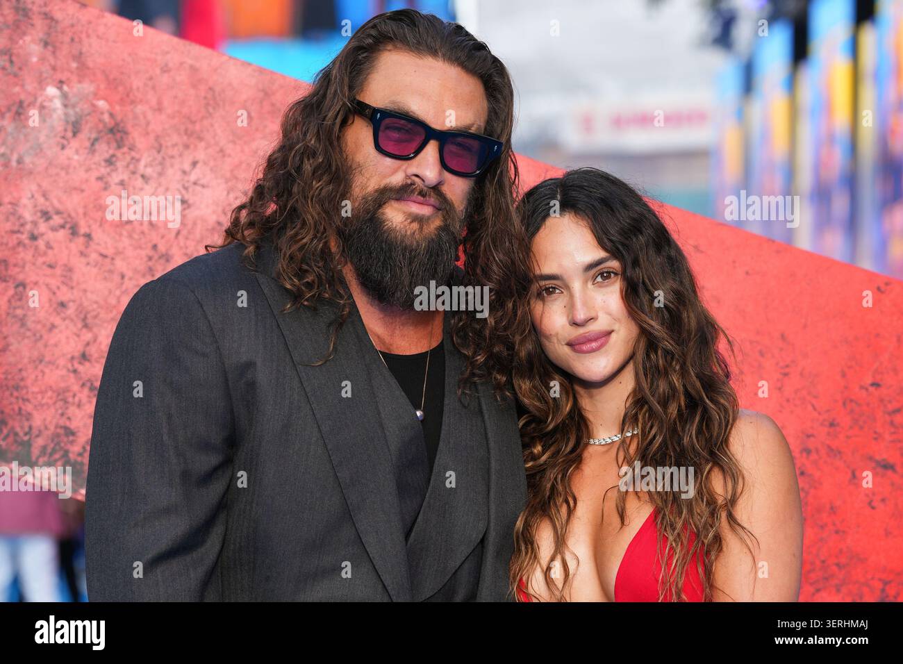 Jason Momoa, left, and Adria Arjona pose for photographers upon arrival ...
