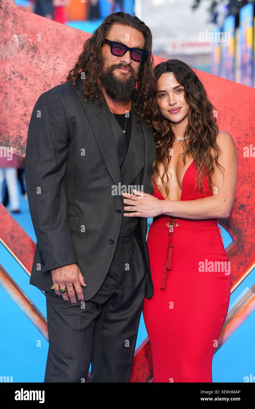 Jason Momoa, left, and Adria Arjona pose for photographers upon arrival ...