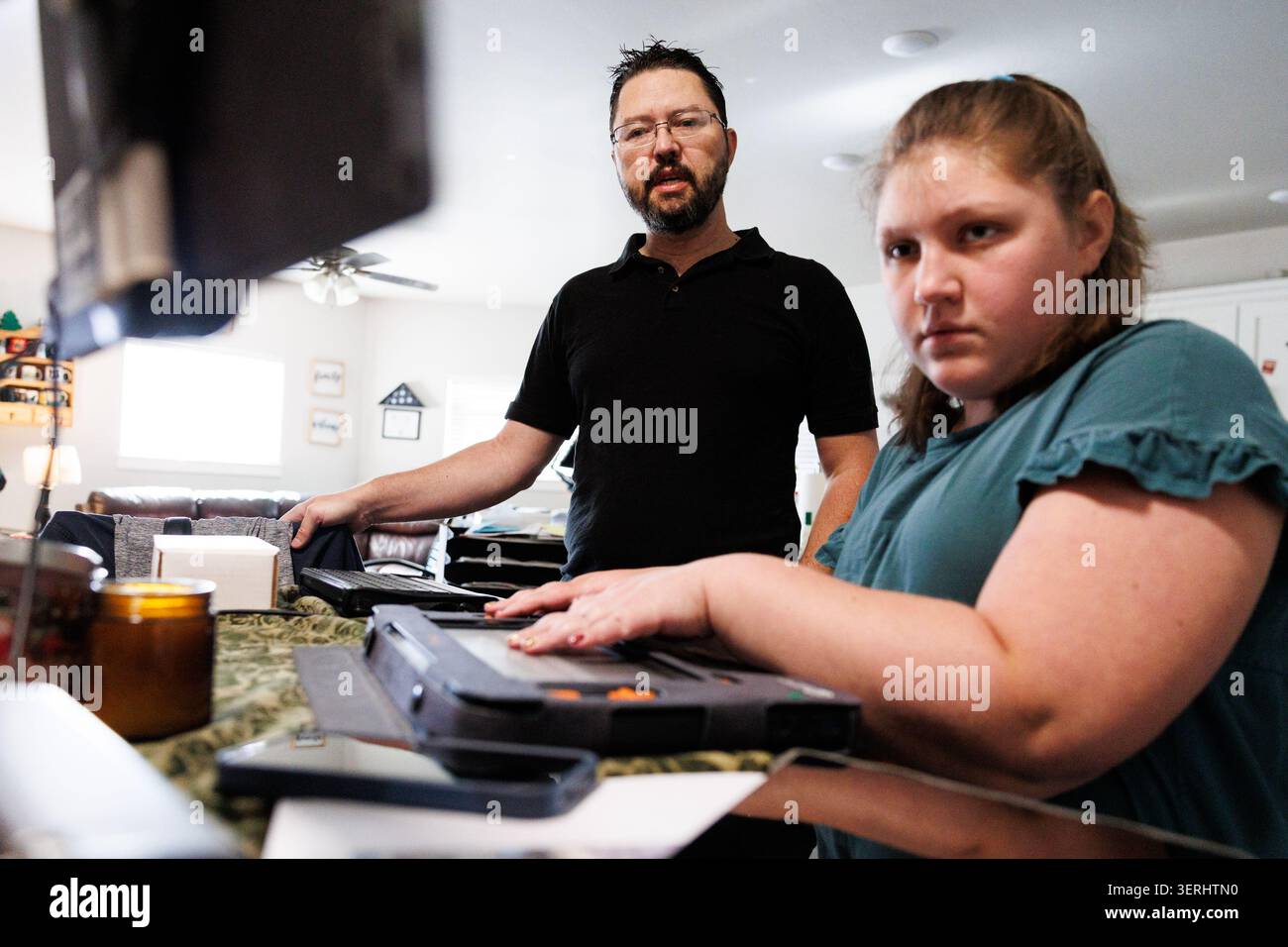 Rob Harris and Isabelle Harris use their braille display on Thursday ...