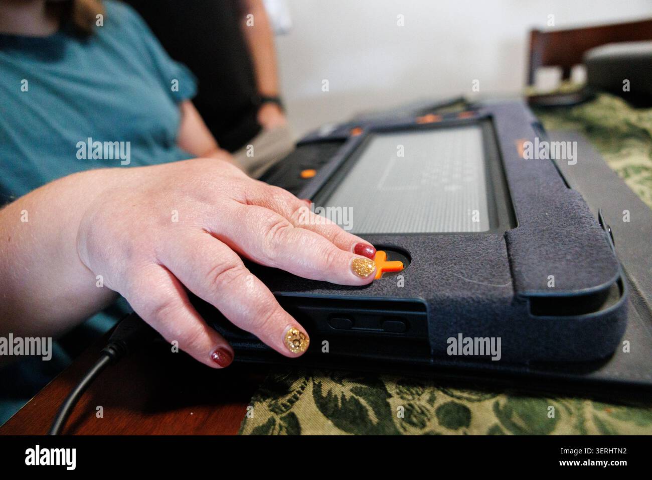 Isabelle Harris uses her braille display on Thursday, June 18, 2026, in ...