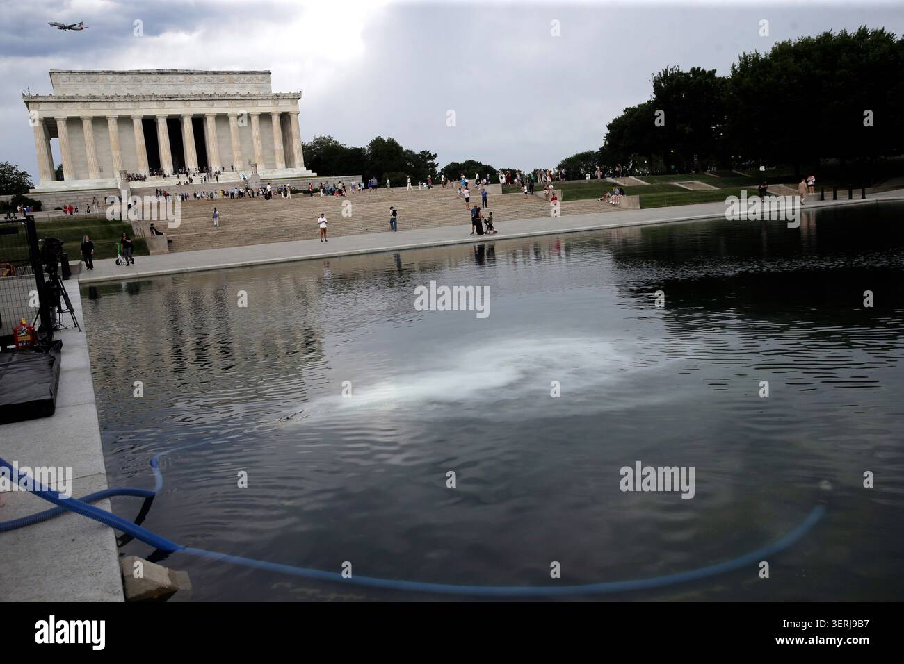 A white chemical is pumped into the Lincoln Memorial Reflecting Pool in ...