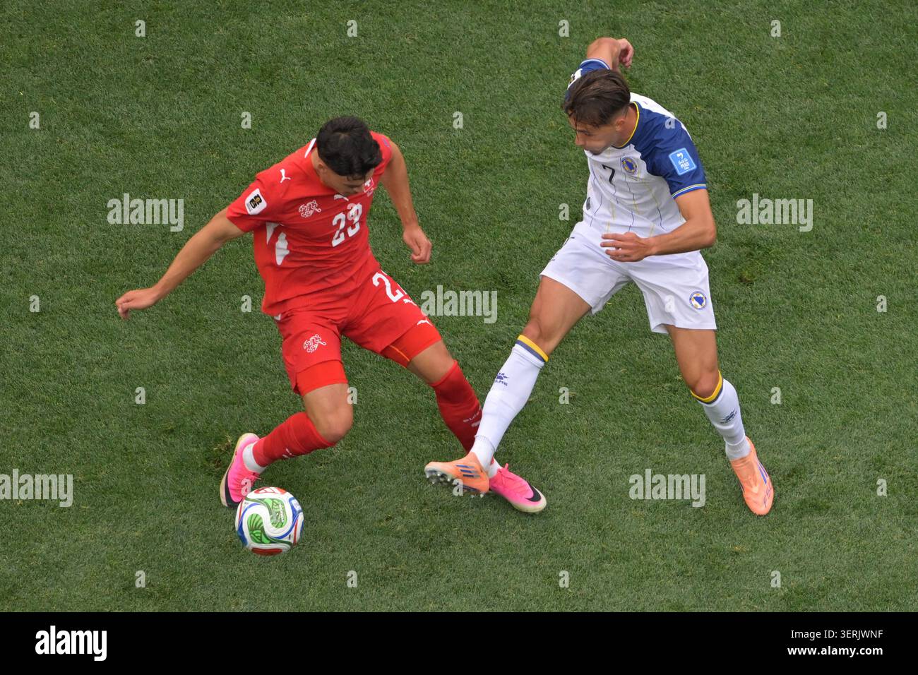 Switzerland's Zeki Amdouni (23) and Bosnia's Amar Dedic (7) fight for ...