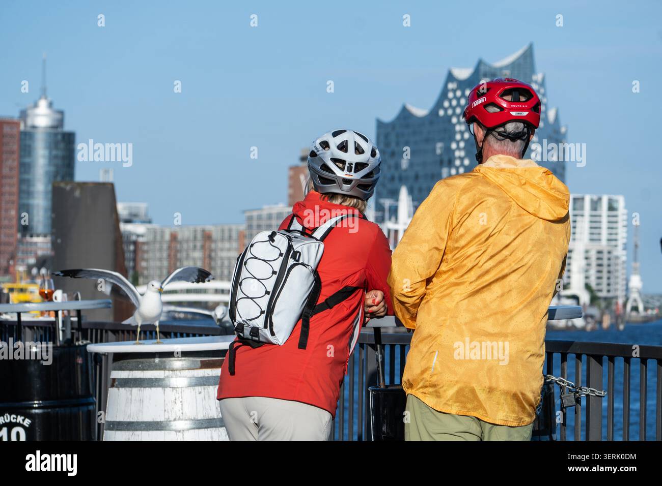A couple with bicycle helmets stands at the Hamburg Landungsbr?cken ...