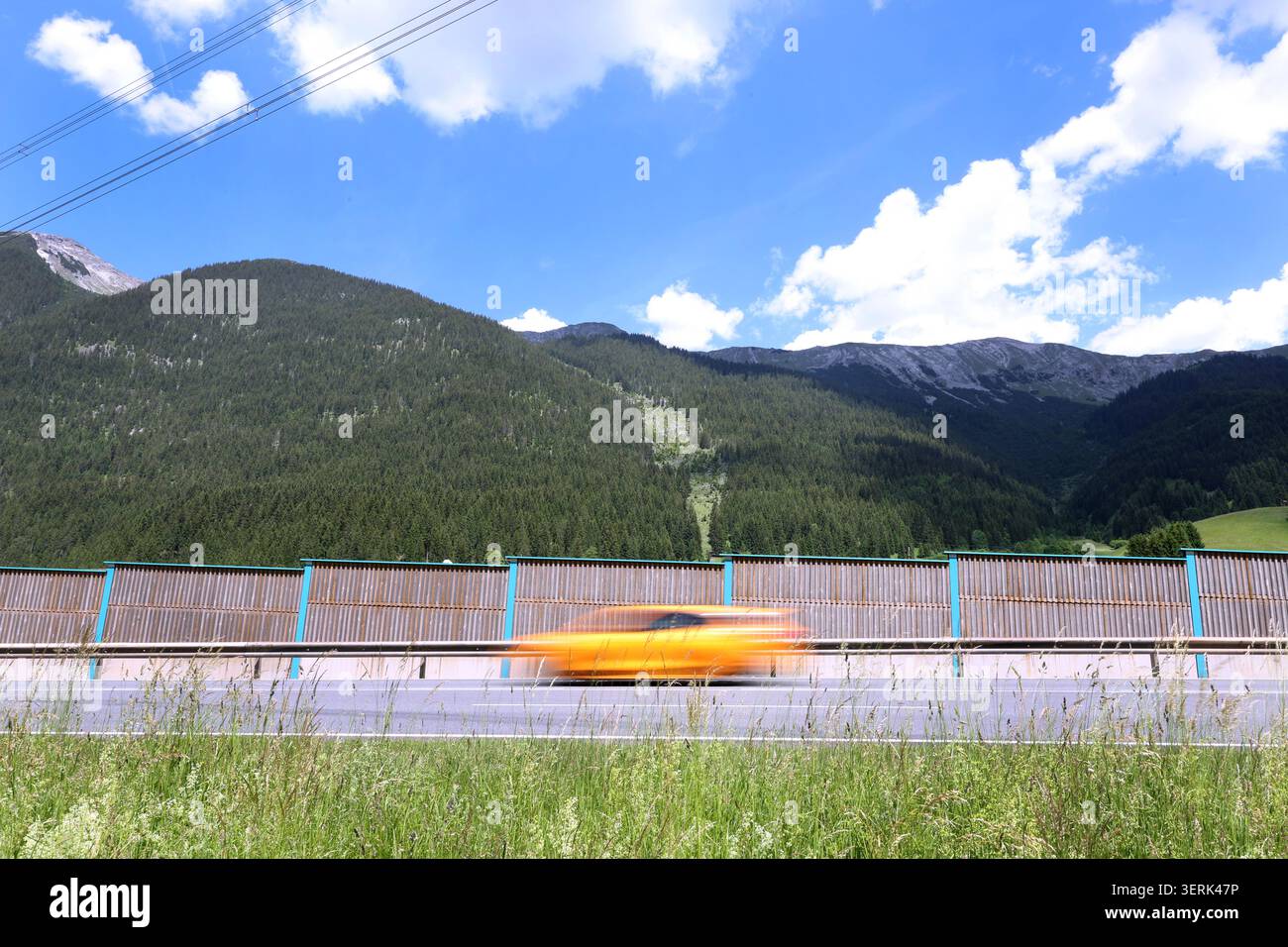 PRODUCTION - 18 June 2026, Austria, Bichlbach: A car drives past a ...