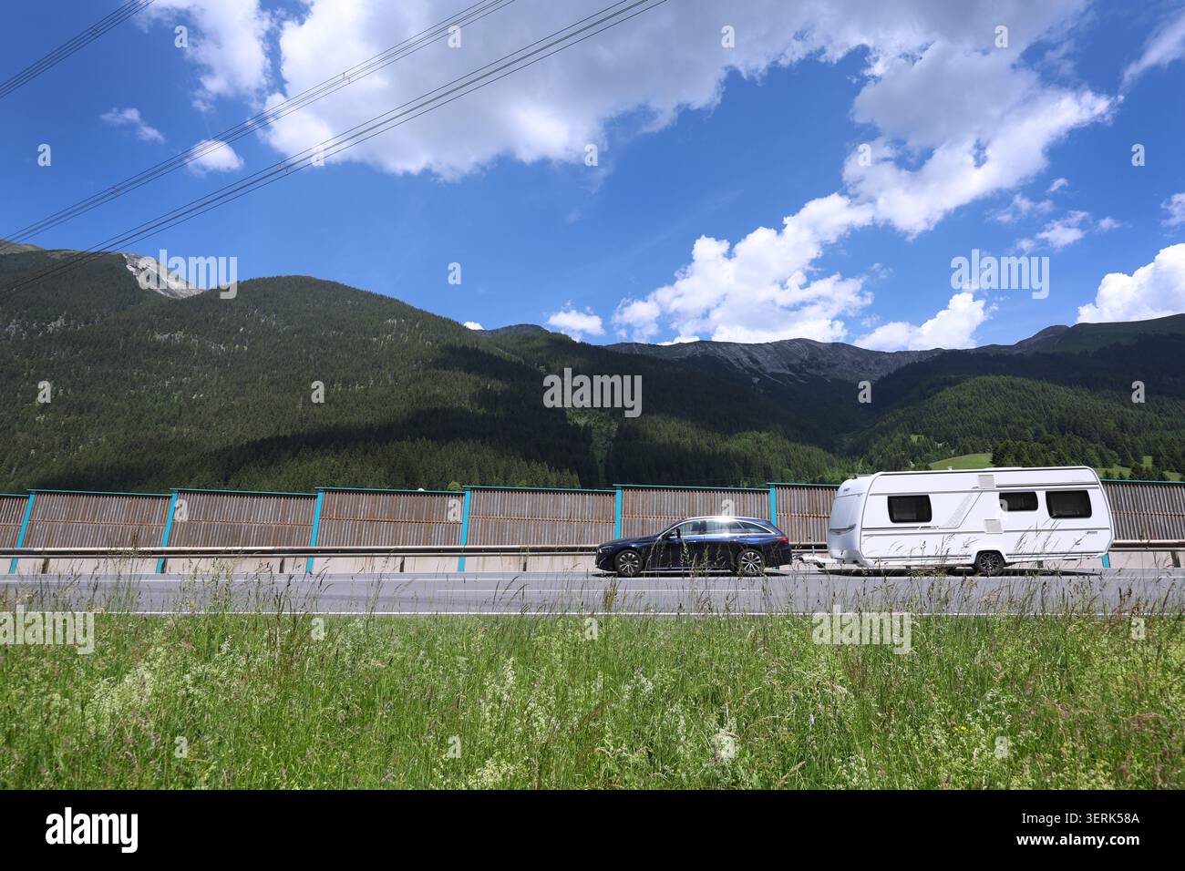 PRODUCTION - 18 June 2026, Austria, Bichlbach: A car pulling a trailer ...