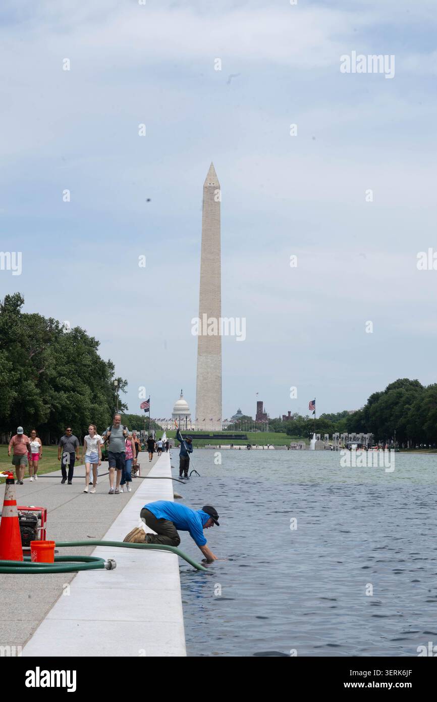Algae is cleaned off of the floor of the Reflective Pool in Washington ...