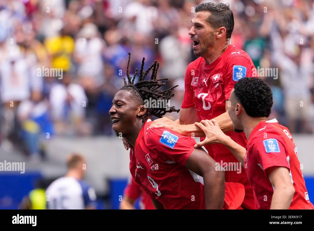 Switzerland's Johan Manzambi, left, celebrates with teammates after ...