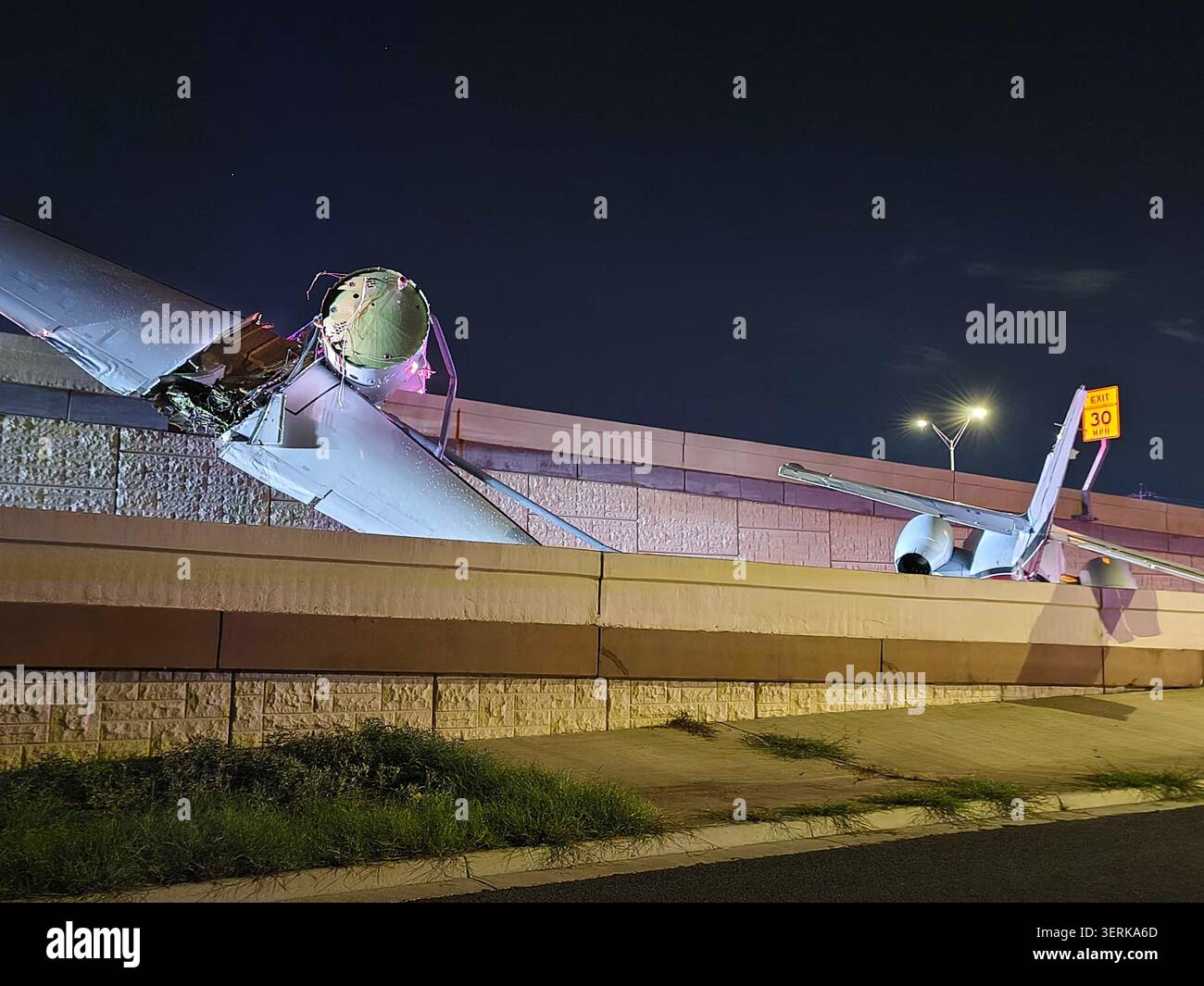 The wreckage of a business jet sits on Loop 20 near the Clark Boulevard ...