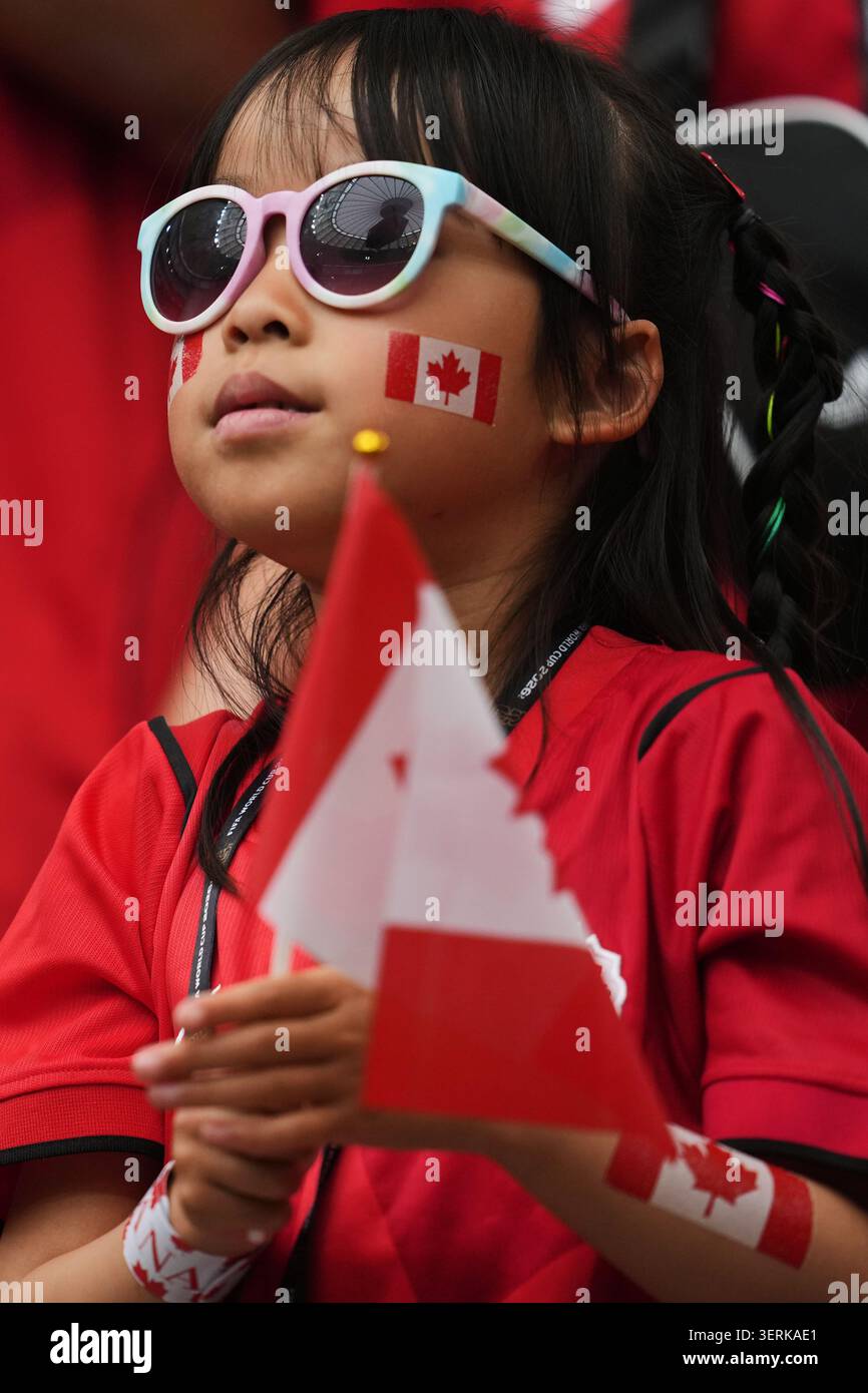 A young fan of Canada watches as teams arrive prior to the World Cup ...