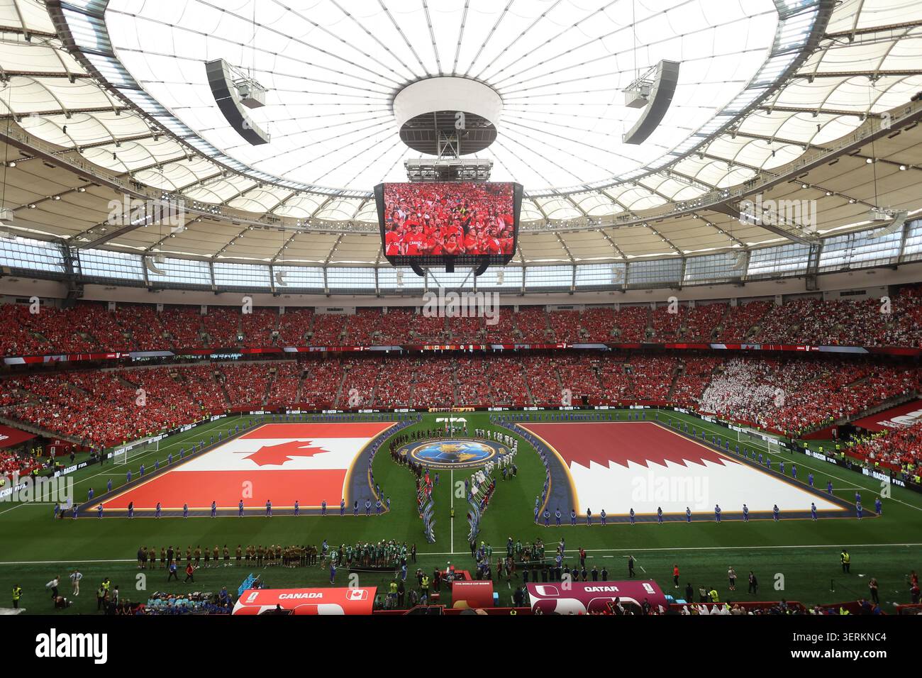 The national flags of Canada and Qatar are displayed during opening ...