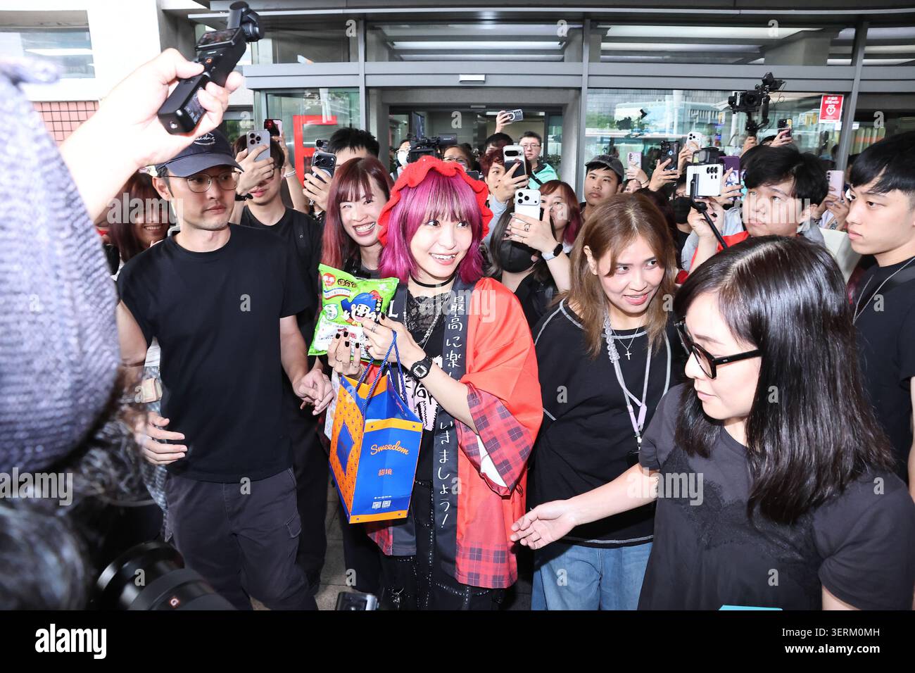 TAIPEI, CHINA - JUNE 18, 2026 - Fans welcome Japanese rock singer LiSA ...