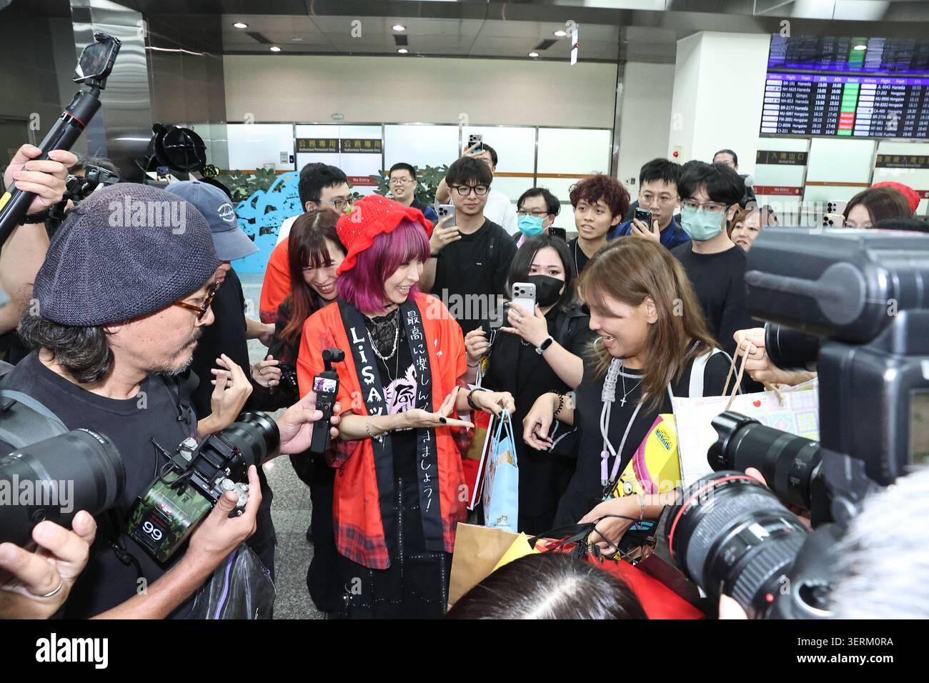 TAIPEI, CHINA - JUNE 18, 2026 - Fans welcome Japanese rock singer LiSA ...