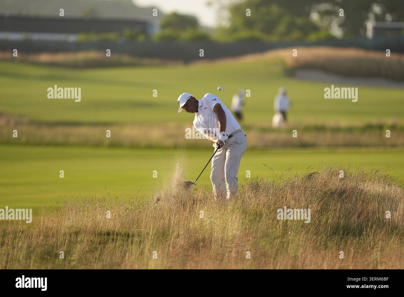 Gary Woodland hits from the tall fescue on the fourth hole during the ...