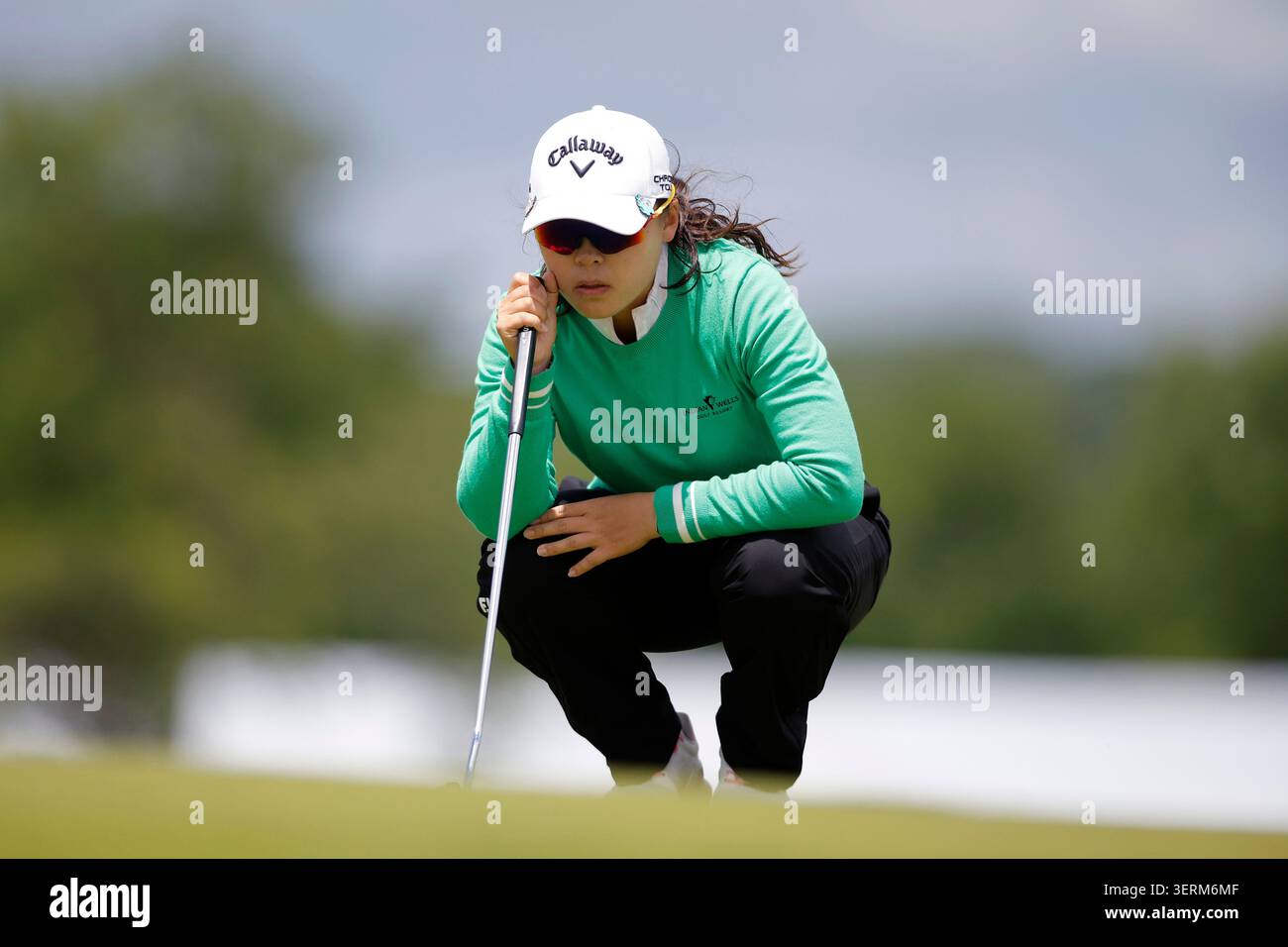 Mary Liu, of China, lines up her putt on the first hole during the ...