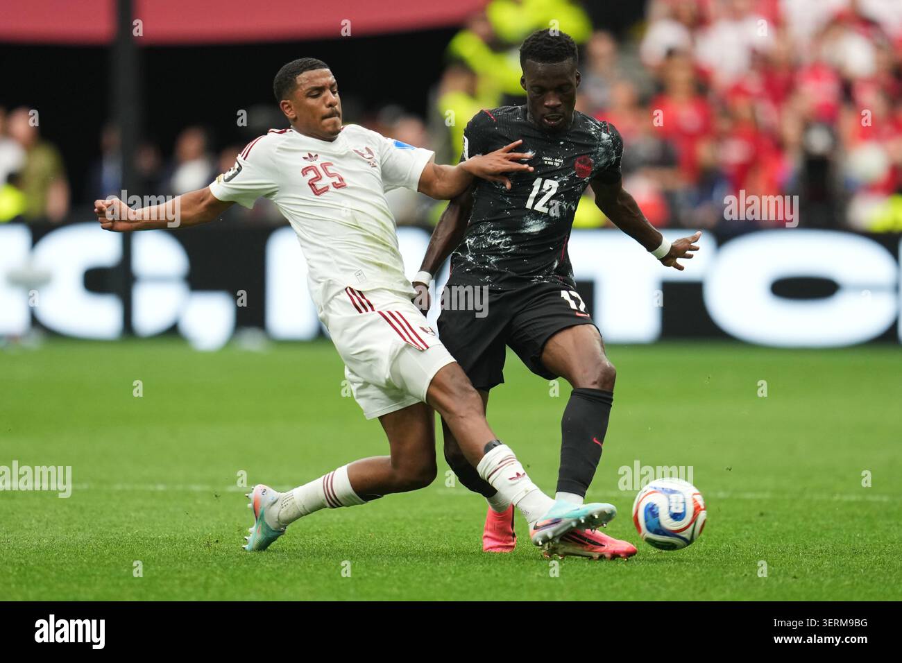 Qatar's Alhashmi Alhussein, left, battles for the ball with Canada's ...