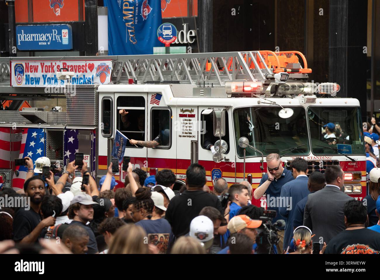 FDNY firefighters wave from their engine during the 2026 NBA ...