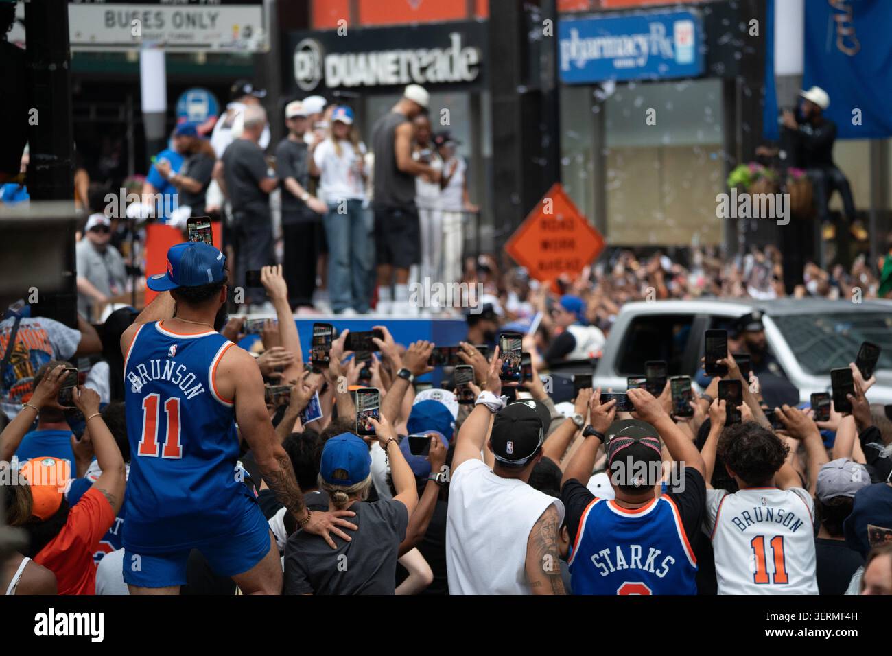 Fans record floats passing by on their phone during the 2026 NBA ...