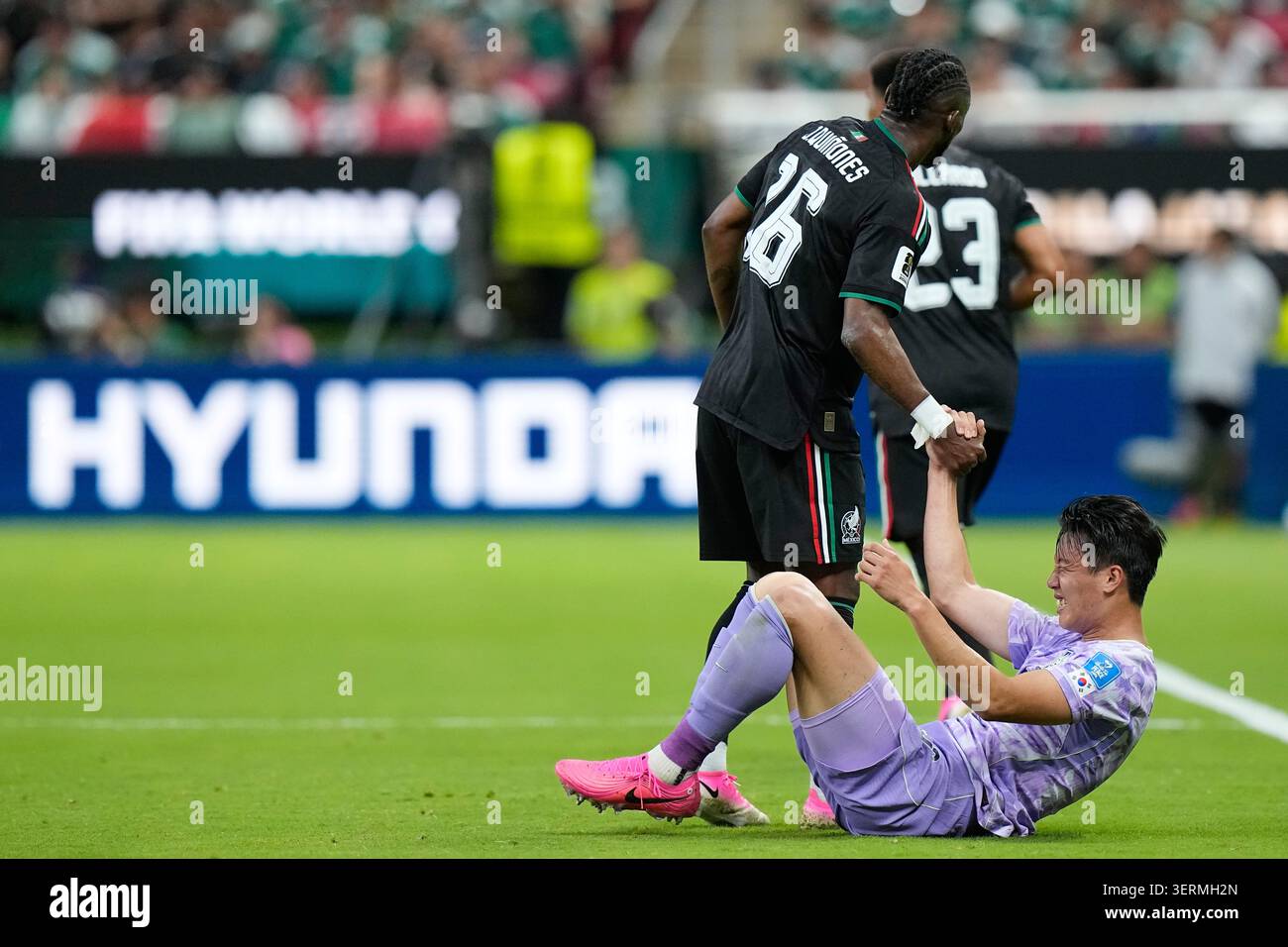 Mexico's Julian Quinones (16) helps up South Korea's Lee Han-beom (2 ...