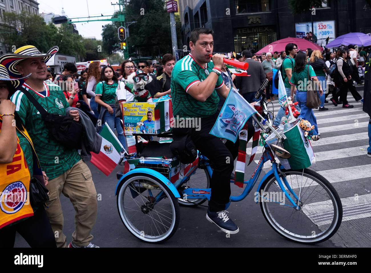 Jorge Rangel rides a bicycle accompanied by his dog, Osito, both ...