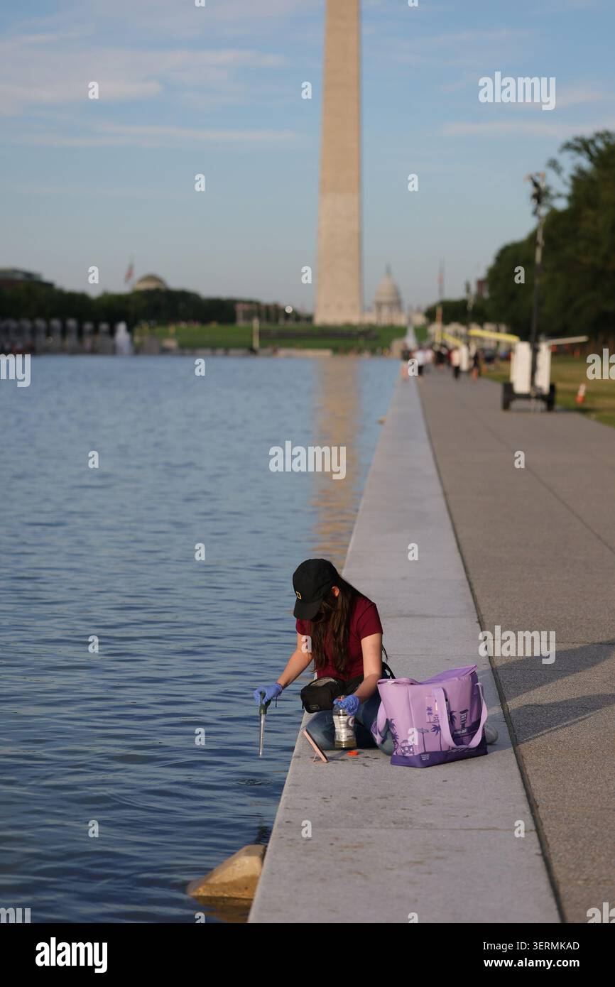 WASHINGTON, D.C. - JUNE 18: A worker tested the water as algae has ...