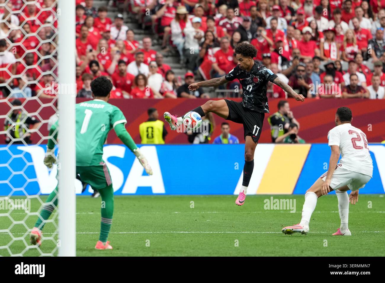 Canada's Tajon Buchanan (17) receives the ball as Qatar's Mohamed Manai ...