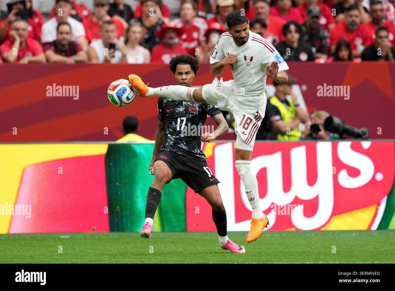 Qatar's Sultan Albrake (18) gets his boot on the ball in front of ...