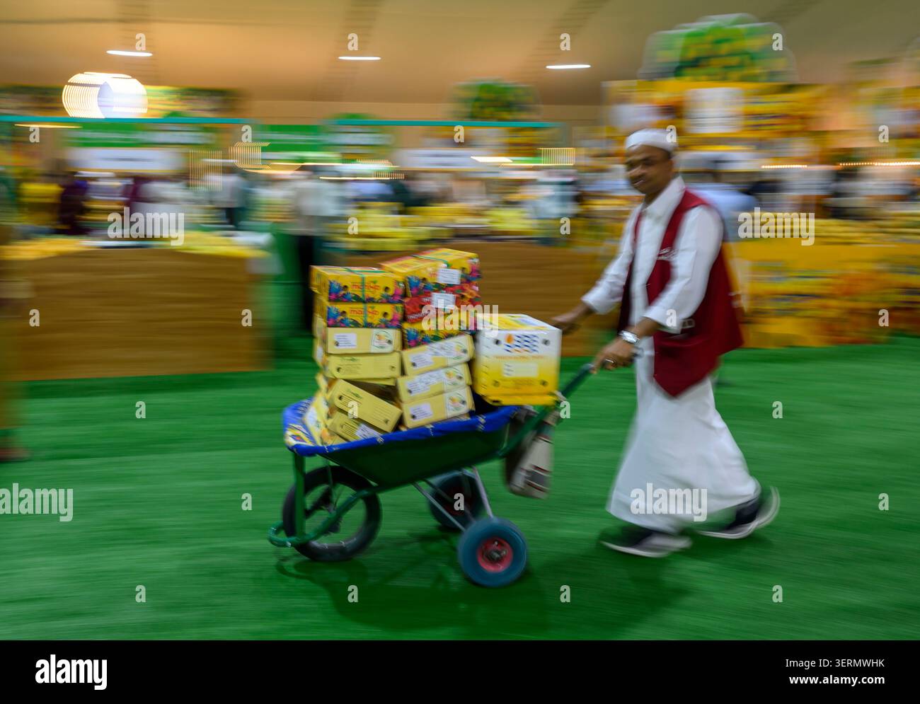 A worker carries mango boxes during the 3rd Indian Mango Festival at ...