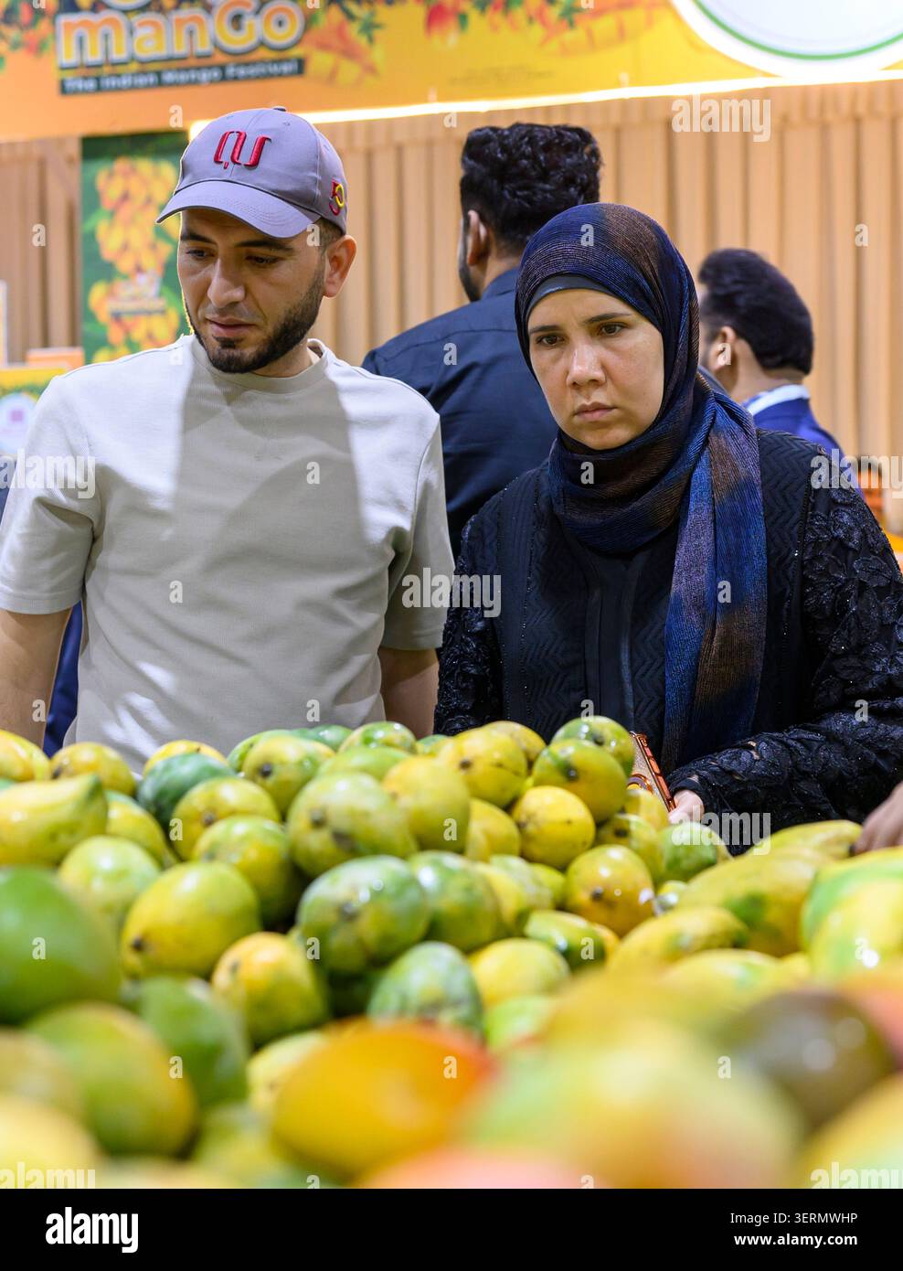 People choose mangoes during the 3rd Indian Mango Festival at Souq ...