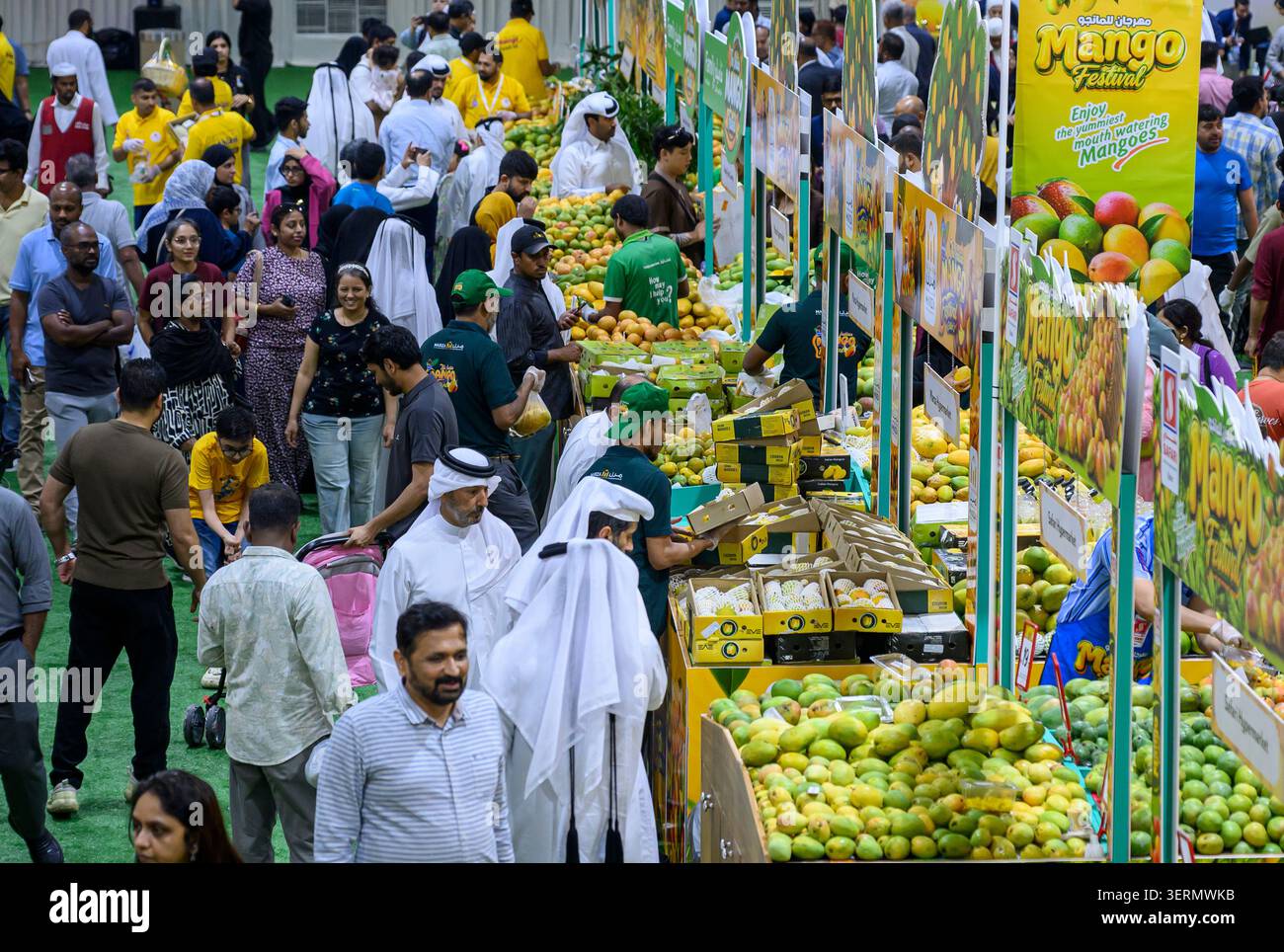 People choose mangoes during the 3rd Indian Mango Festival at Souq ...