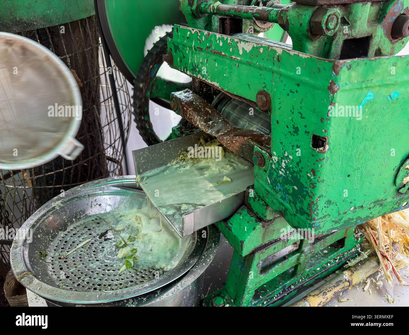 fresh sugarcane juice being prepared with mechanical crusher at ...