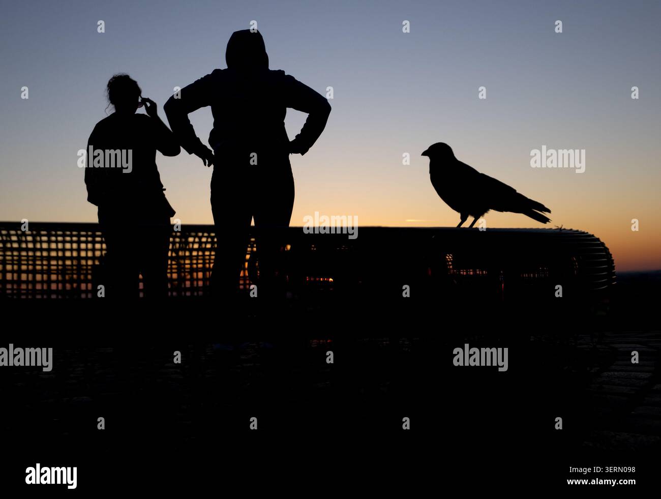19 June 2026, Bavaria, Munich: Early risers watch the sunrise on ...