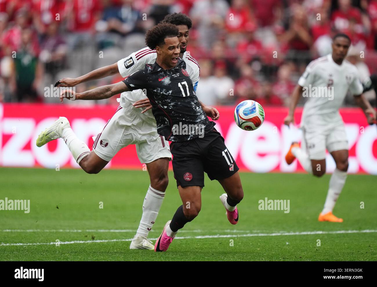 Canada's Tajon Buchanan (17) is tackled by Qatar's Homam Ahmed (14 ...