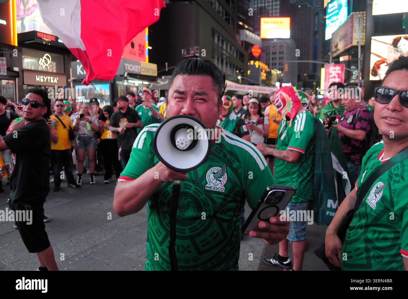 A fan of the Mexican national soccer team talks using a loudspeaker in ...