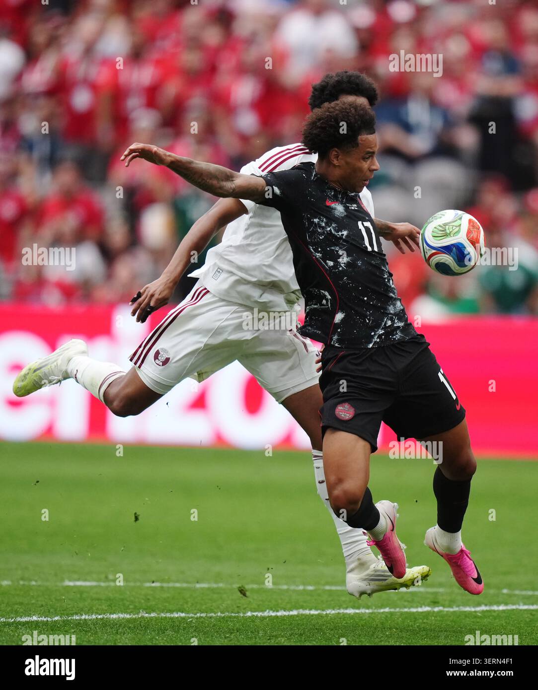 Canada's Tajon Buchanan (17) is tackled by Qatar's Homam Ahmed (14 ...
