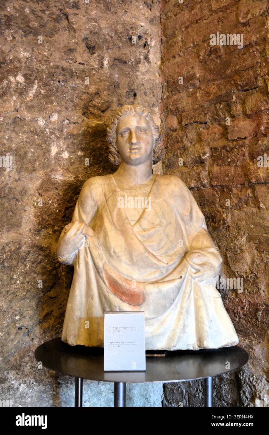 San Gimignano, Italy 03.04.2020: ancient marble sculpture placed on a ...