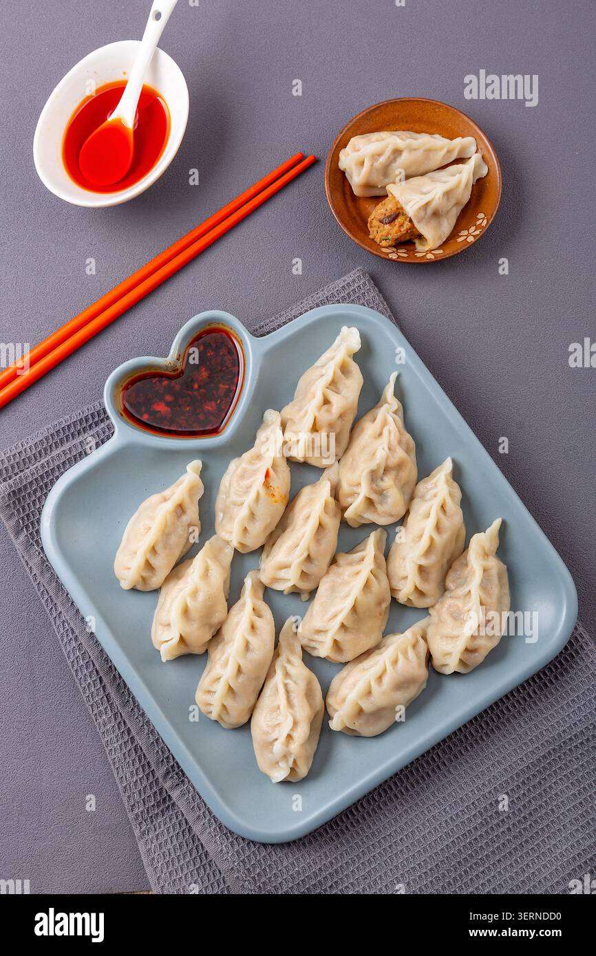 Freshly boiled Chinese pork and radish dumplings Jiaozi with spicy ...