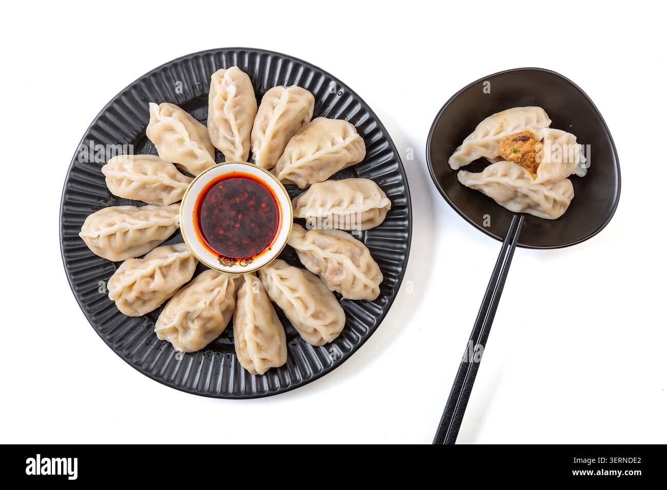 Freshly boiled Chinese pork and radish dumplings Jiaozi with spicy ...