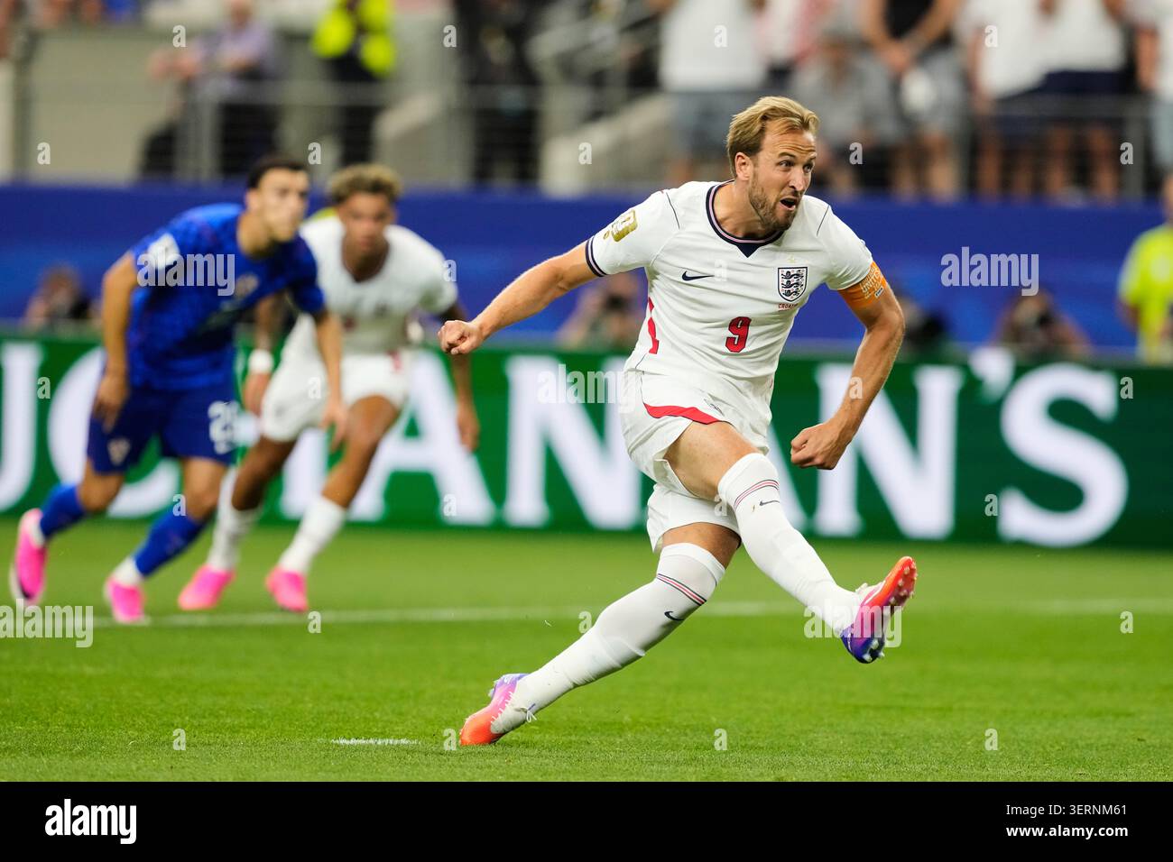 England's Harry Kane scores his team's opening goal on a penalty kick ...
