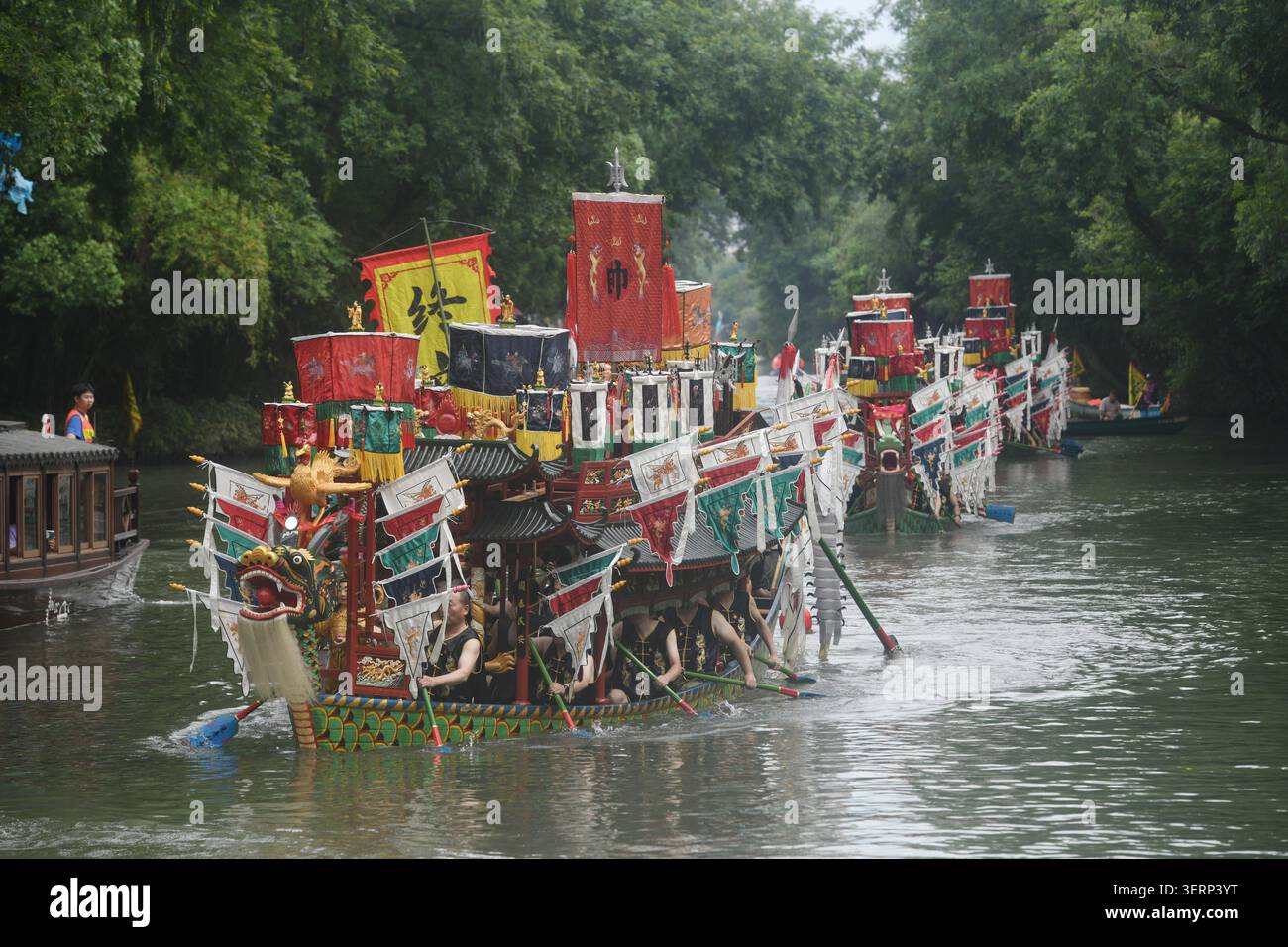 Locals row a traditional dragon boat in a race in the Xixi Wetland in ...