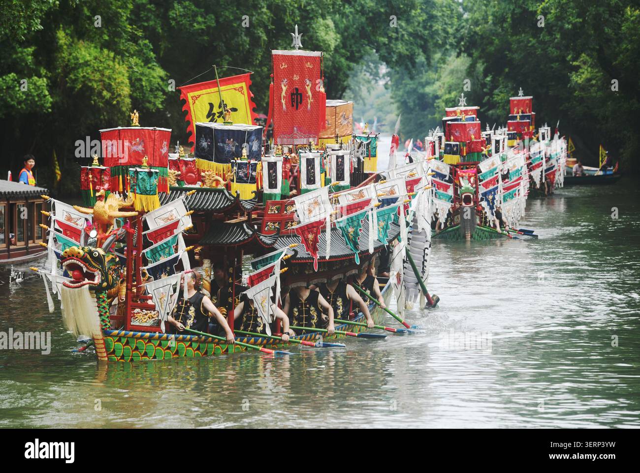 Locals row a traditional dragon boat in a race in the Xixi Wetland in ...